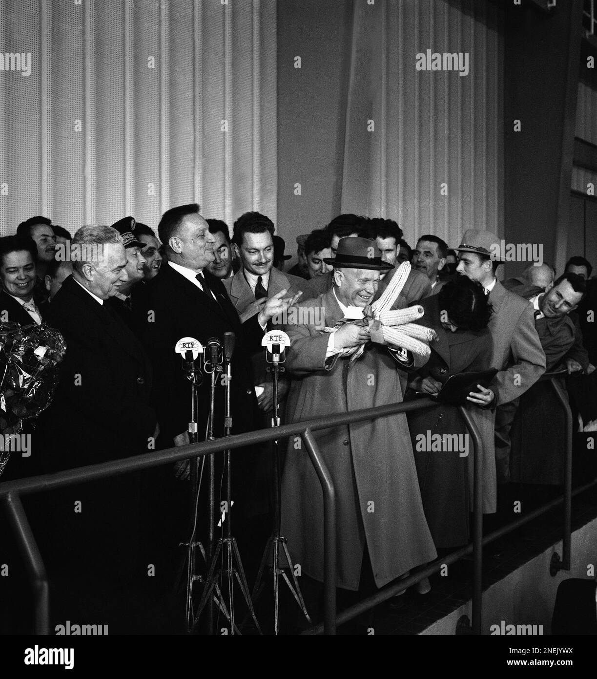 A smiling Soviet Premier Nikita Khrushchev holds ears of corn presented ...