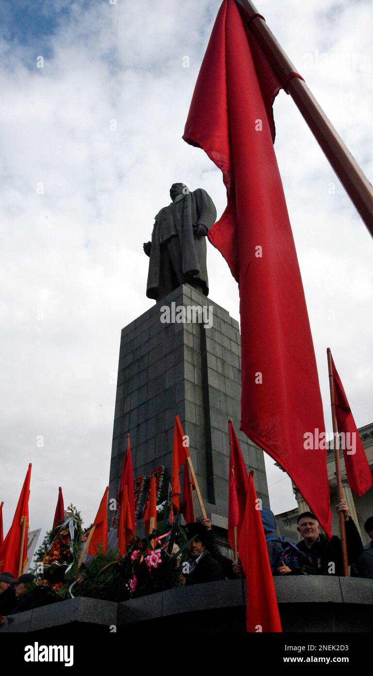 Standing near a statue, background, of Soviet dictator Josef Stalin ...