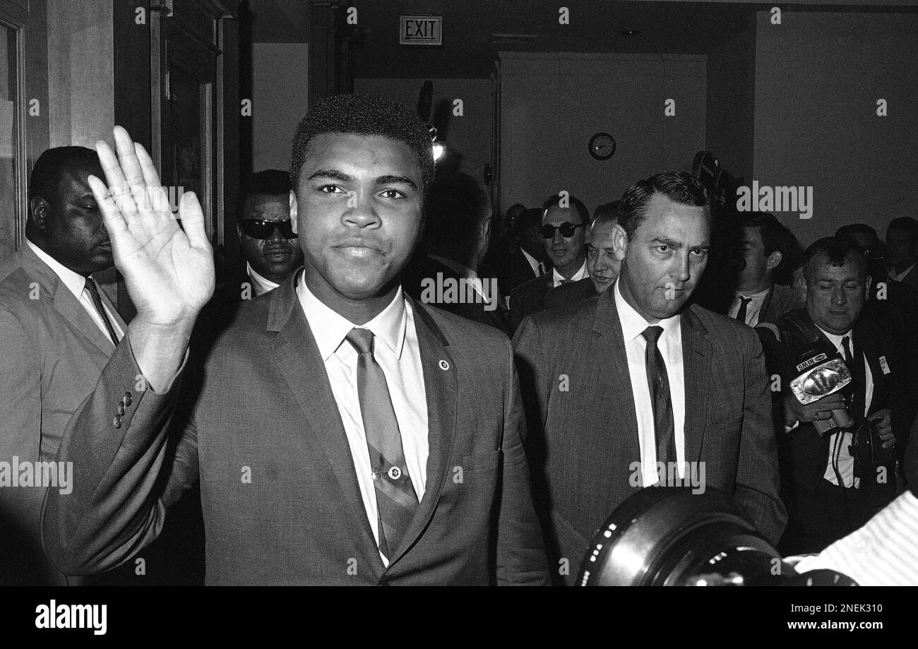 Heavyweight champion Muhammad Ali ?Cassius Clay? raises his hand in a ...