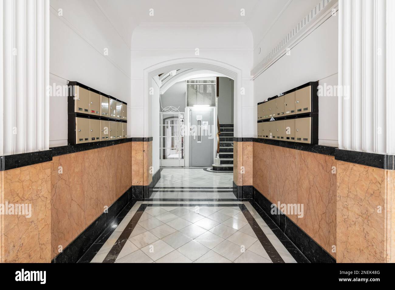 Long hall on the walls with orange marble tiles mailboxes on both sides ...