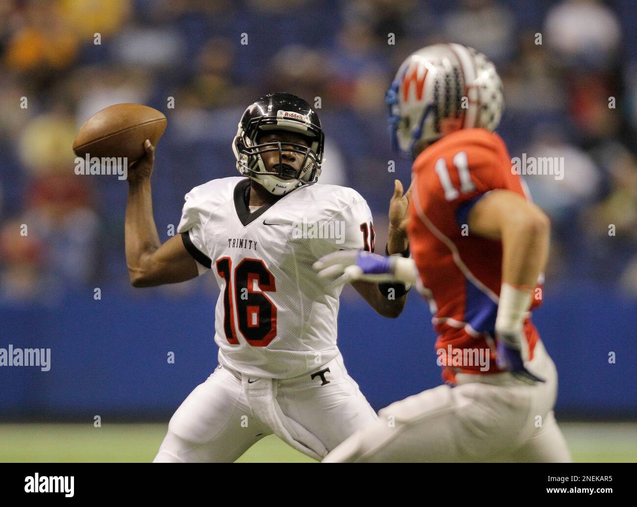 Euless Trinity's Willie Hubbard (16) is hit by Austin Westlake defender ...