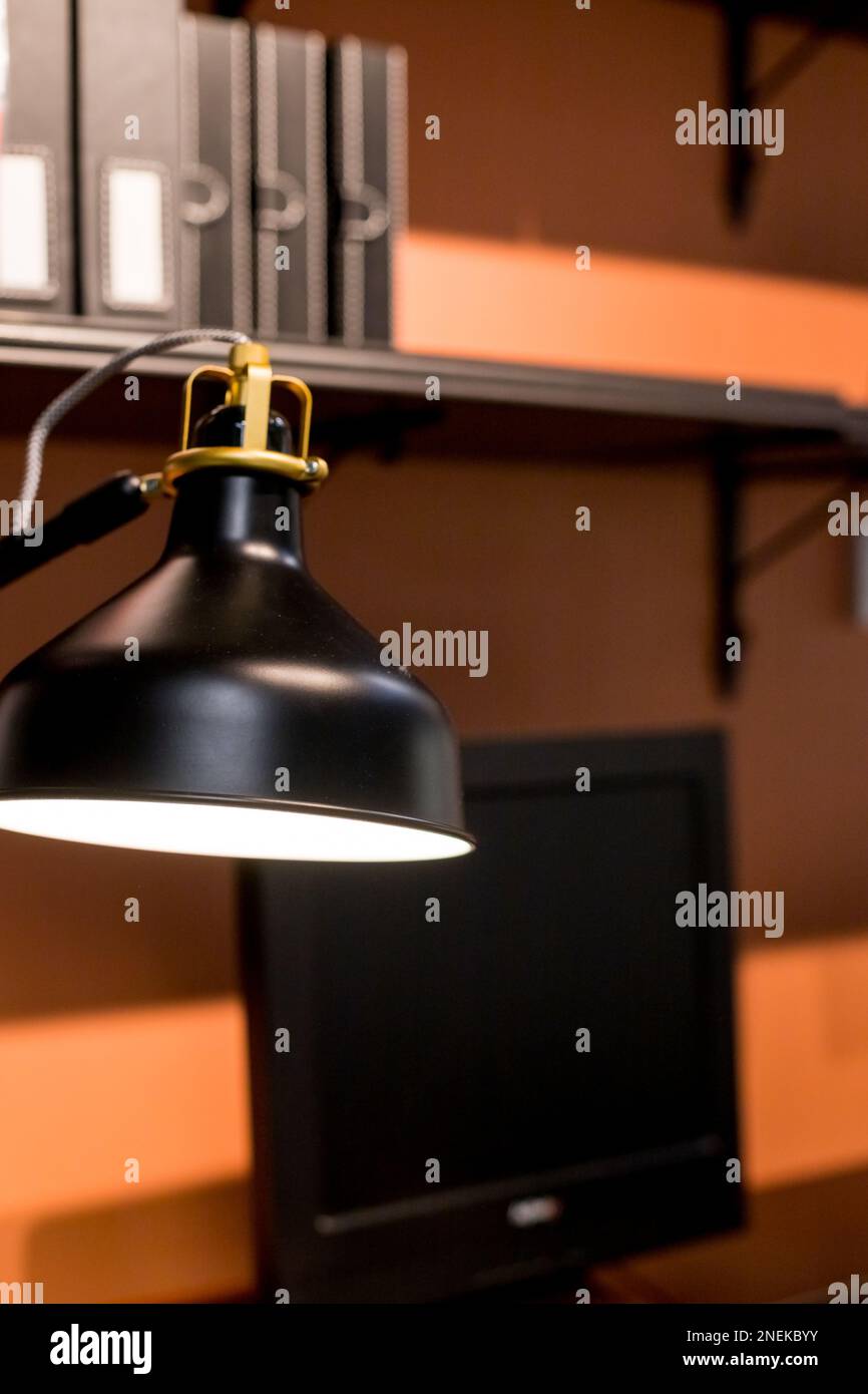 black lamp and laptop stand on desk, on office background, isolated ...