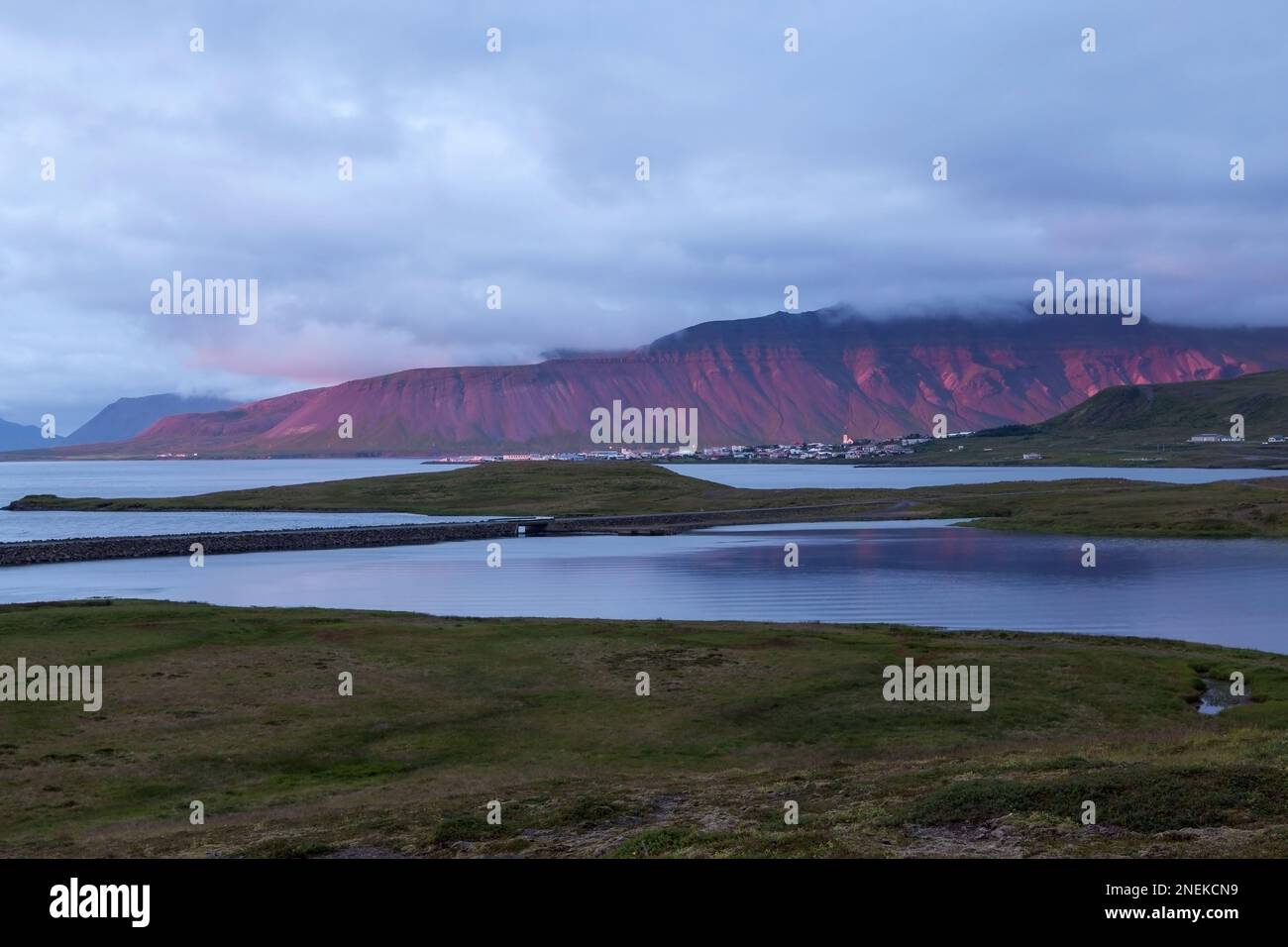 Stunning red mountain behind Grundarfjordur town lit up by the sunset ...