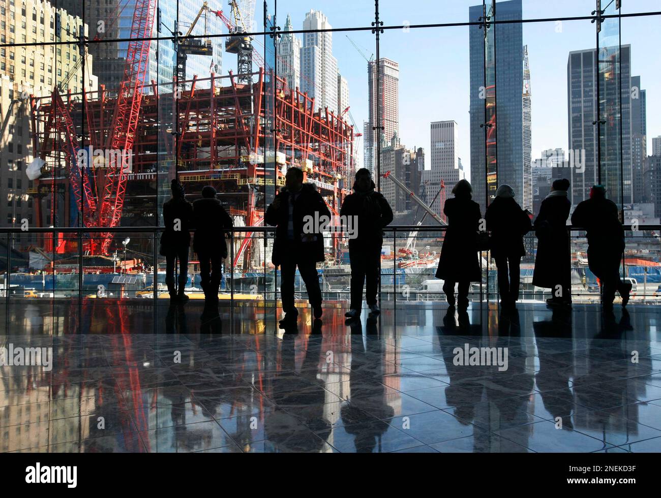 Visitors to the World Trade Center look at the rising steel frame, left ...