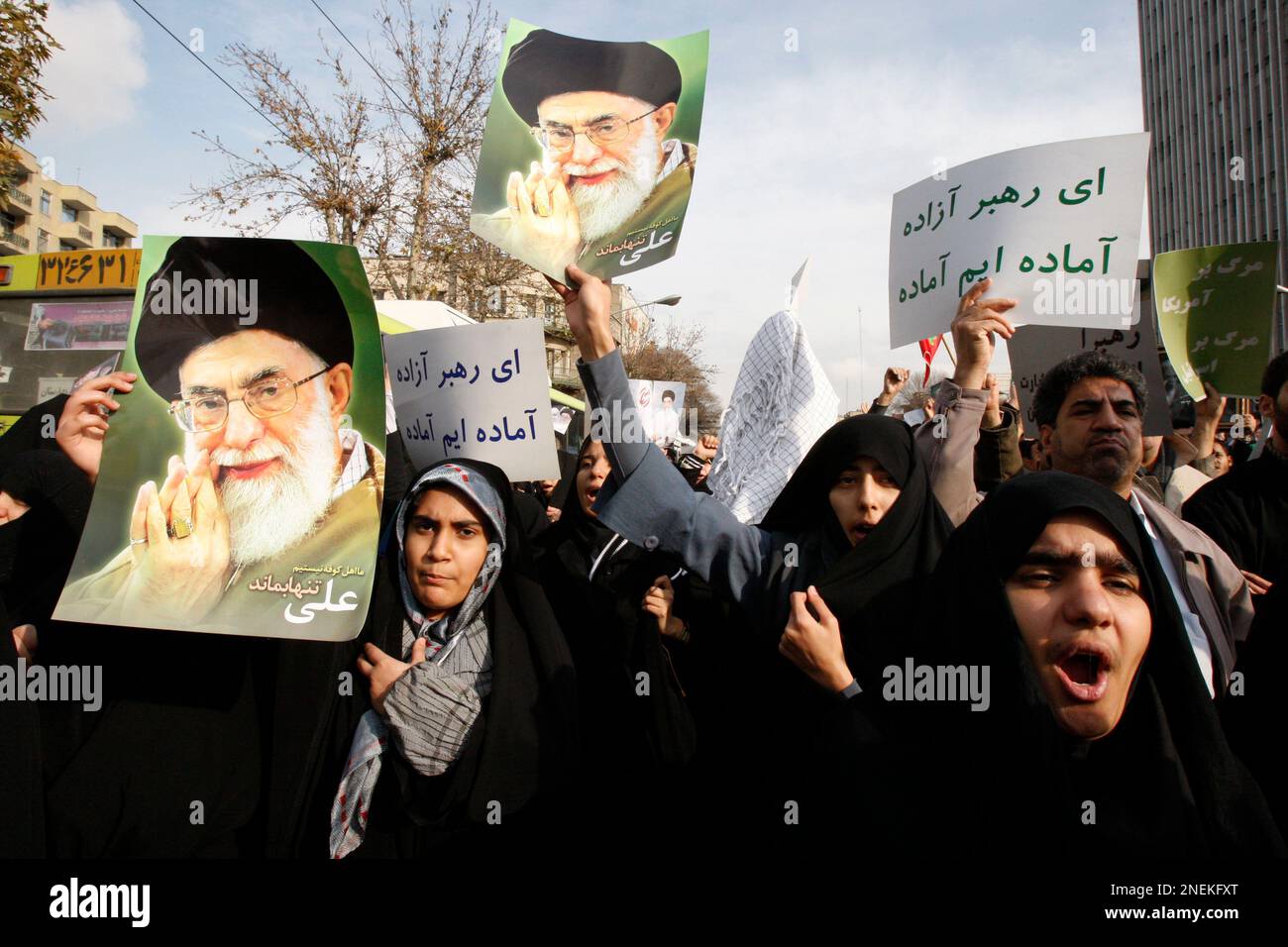 Iranian demonstrators hold posters of supreme leader Ayatollah Ali ...
