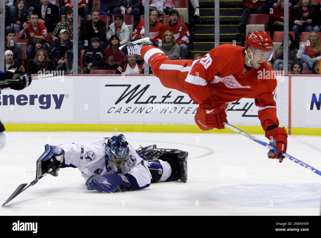 Detroit Red Wings Drew Miller, right, flies through the air while ...