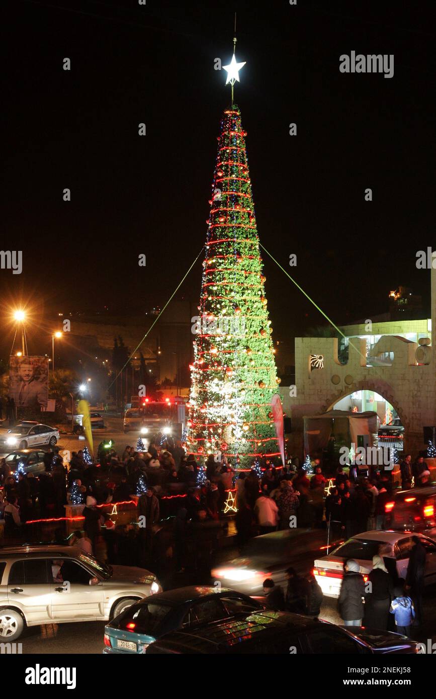 Jordanians gather to celebrate the lighting of the 26-meter tree ...