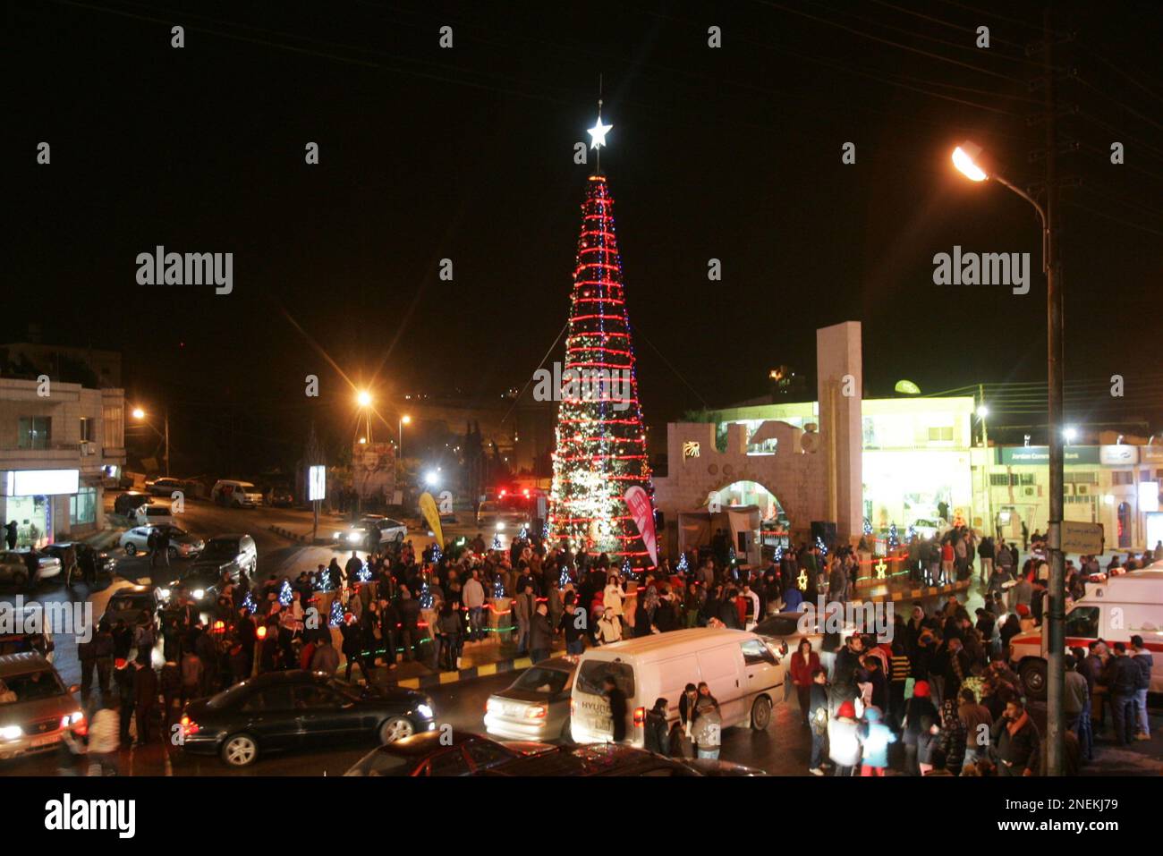 Jordanians gather to celebrate the lighting of the 26-meter tree ...