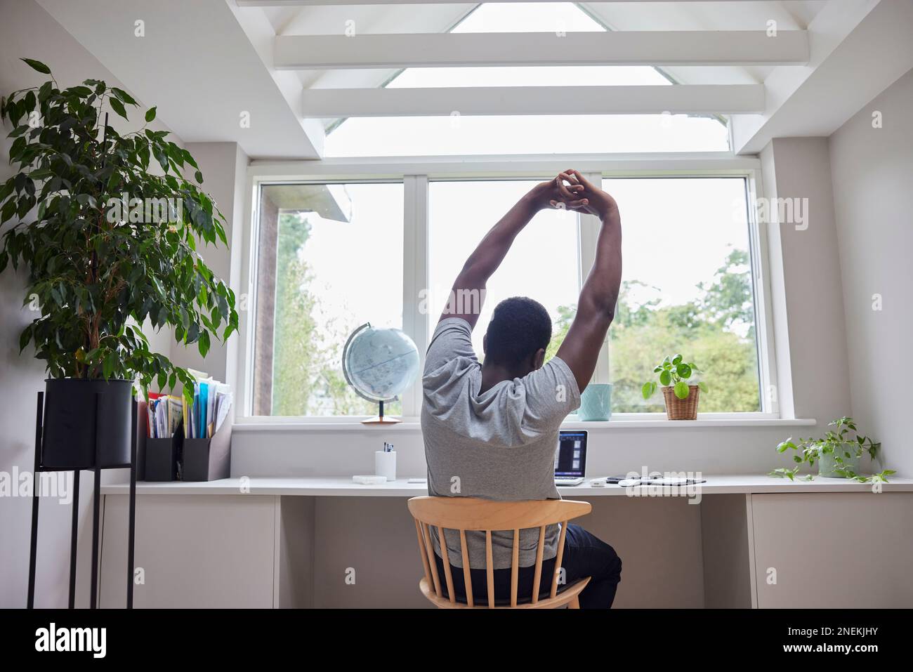 Rear View Of Man Working From Home On Computer In Home Office ...