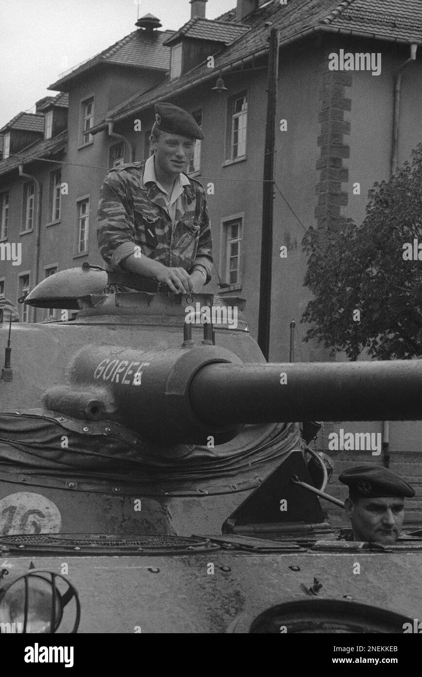 Sergeant Johnny Hallyday of the French Marines straddles a tank, May 9 ...