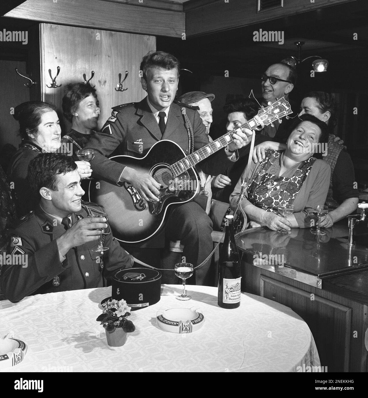 French rock ?n? roll idol Johnny Hallyday (with guitar) is pictured, May 6, 1965 in Offenburg ...