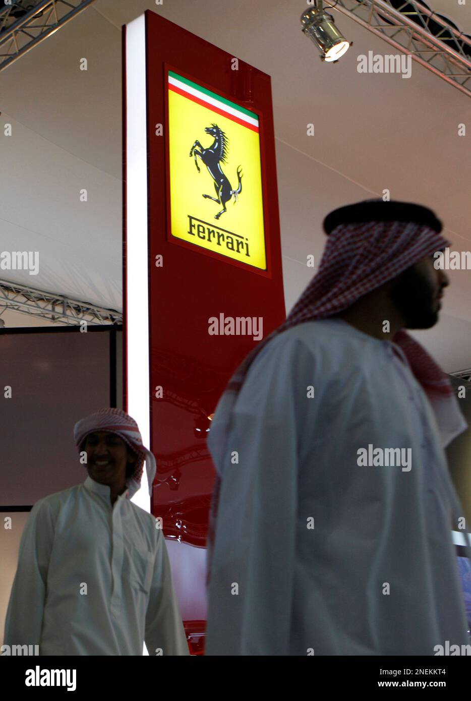Emirati men visit the Ferrari stand at the Dubai International Motor ...