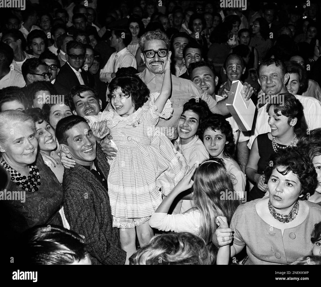 Zenaida Monzon reaches up to pat cheek of her father, Pedro Monzon, as ...