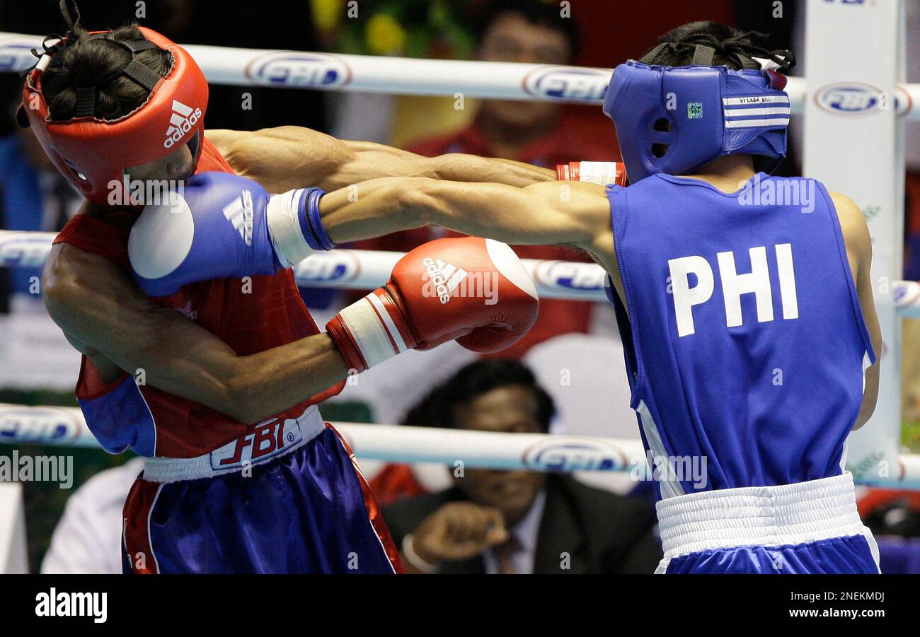 Vicera Bill of the Philippines, right, punches Lao Sikham Vongpakhoun ...
