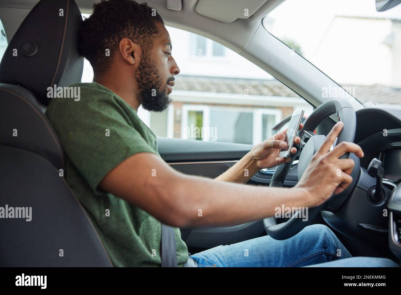 Man Texting Or Using Mobile Phone Whilst Driving Car Stock Photo - Alamy