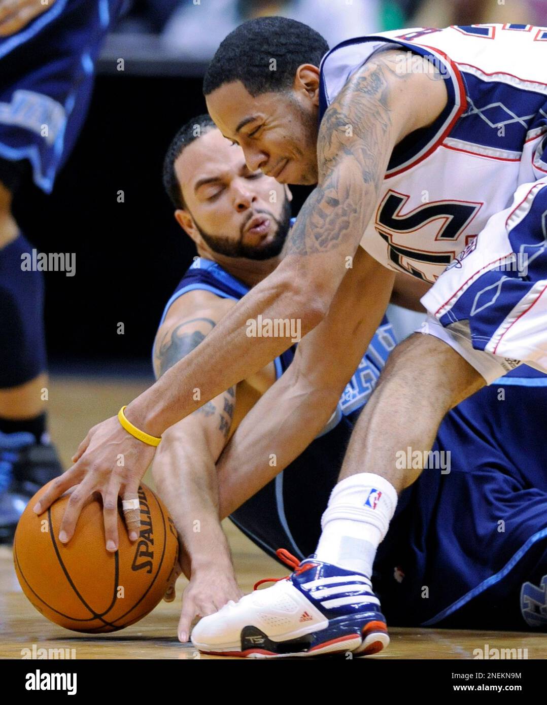 New Jersey Nets guard Devin Harris, right, scrambles for a loose ball ...