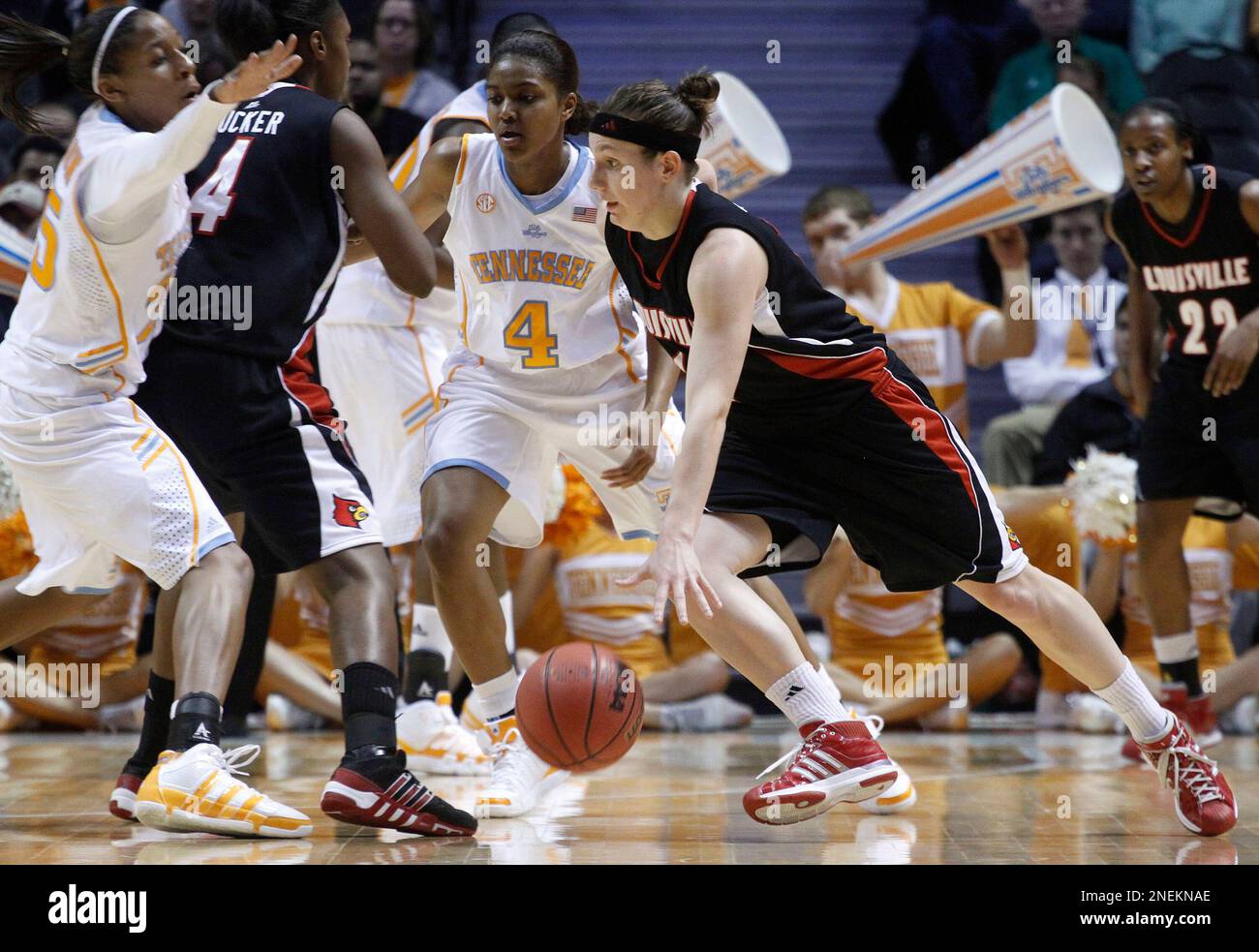 Louisville's Becky Burke, right, drives against Tennessee's Kamiko ...