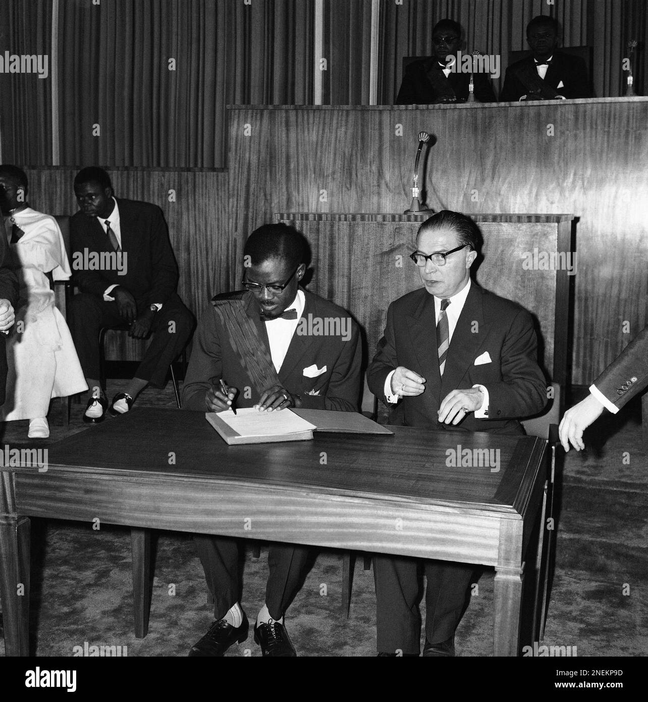 Patrice Lumumba, the prime minister of the Congo, signs the act of ...