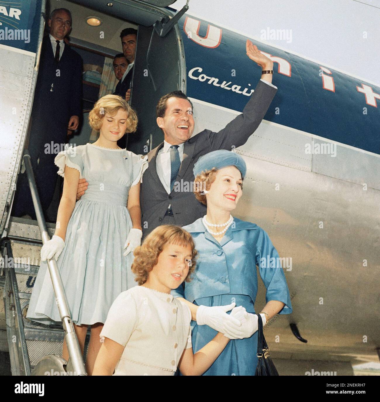 Vice President Richard M. Nixon and family, waving getting off plane ...