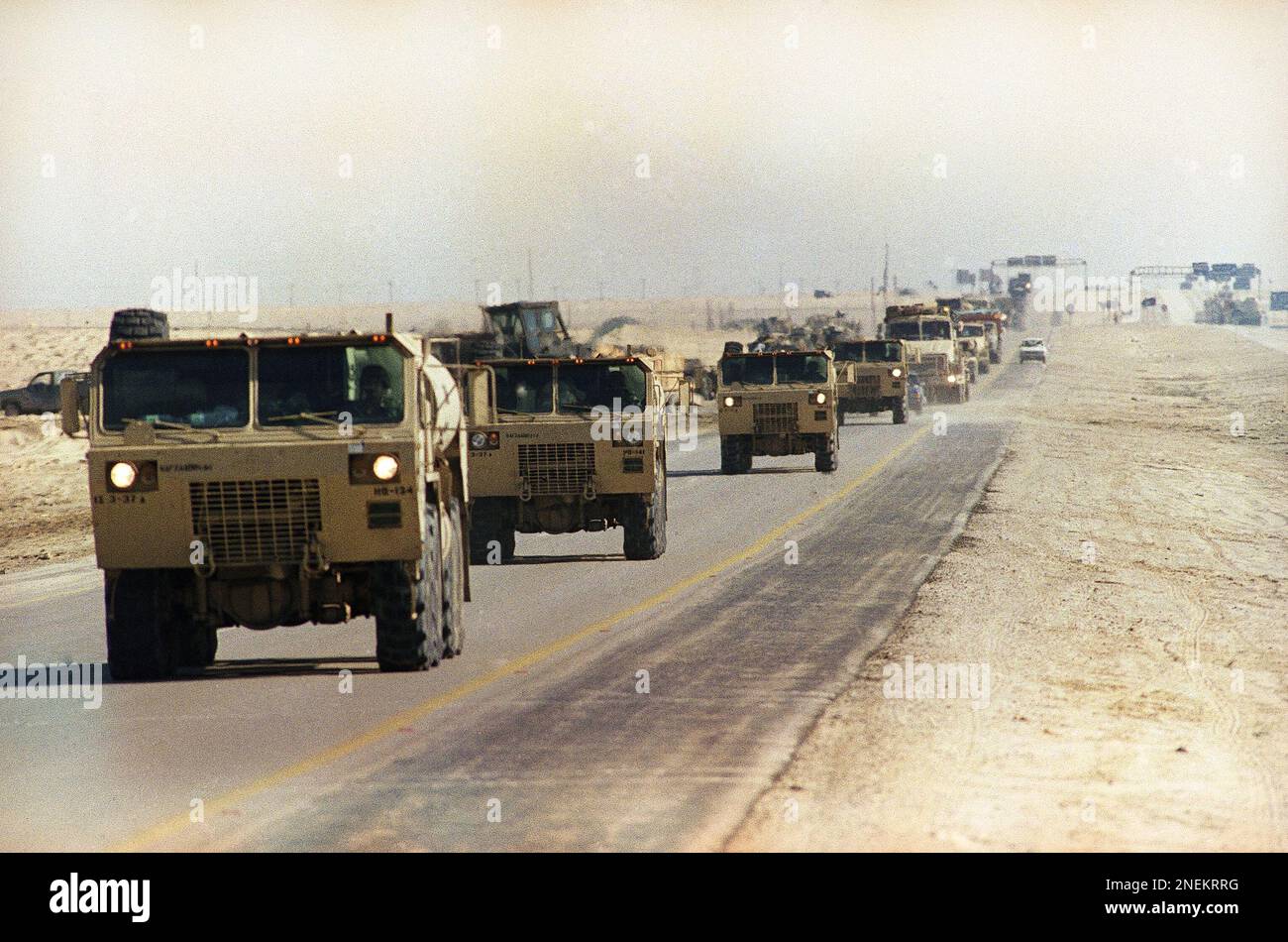 A convoy of allied military vehicles head westward paralleling the ...