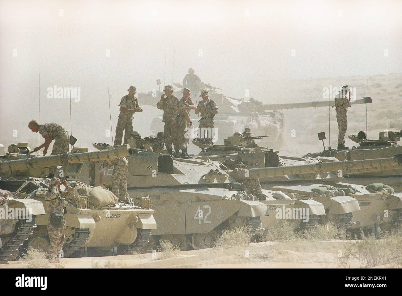 Tank crews with the British 7th Armoured Brigade stand atop their ...