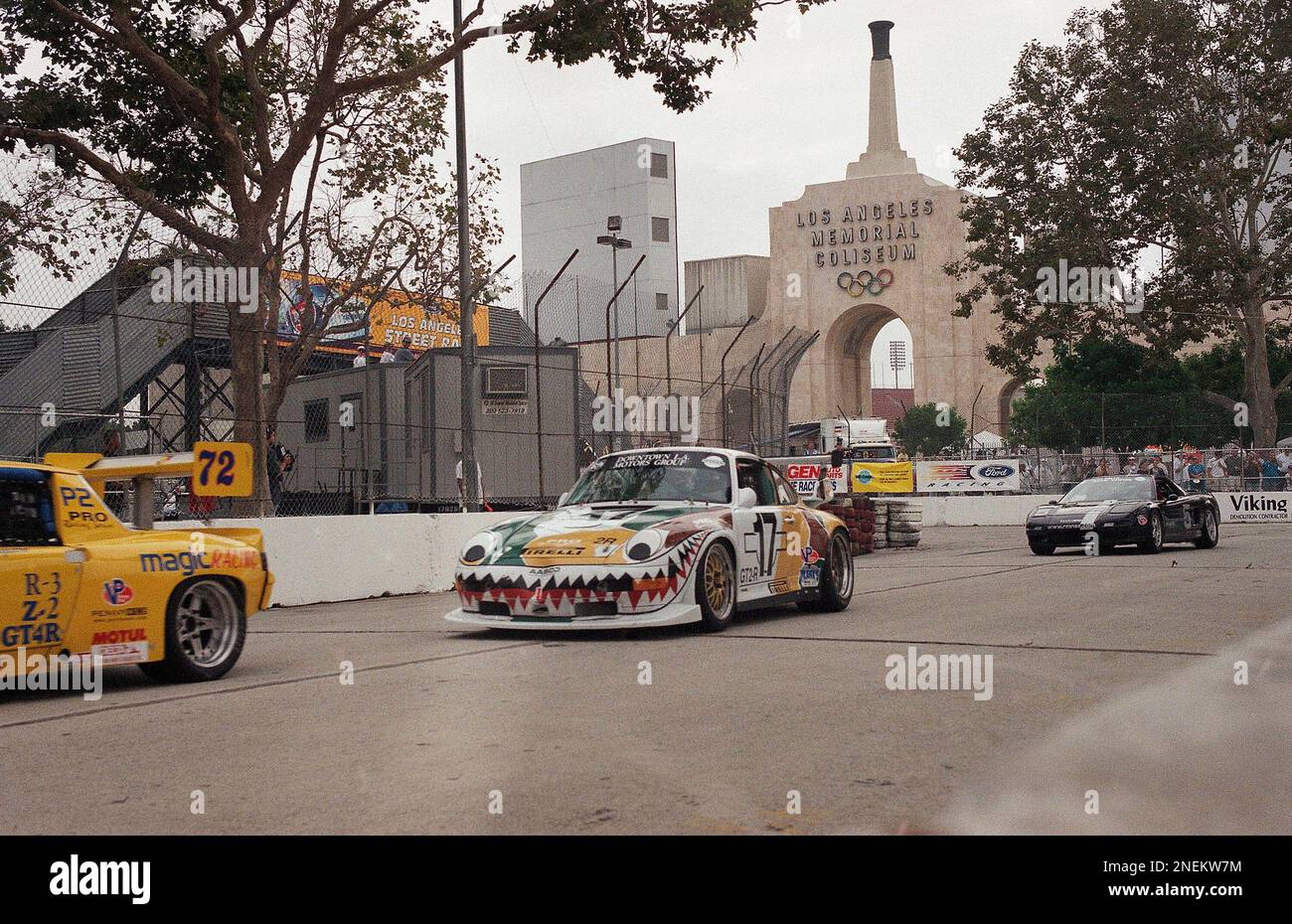 With the peristyle of the Los Angeles Coliseum as a backdrop, cars of ...