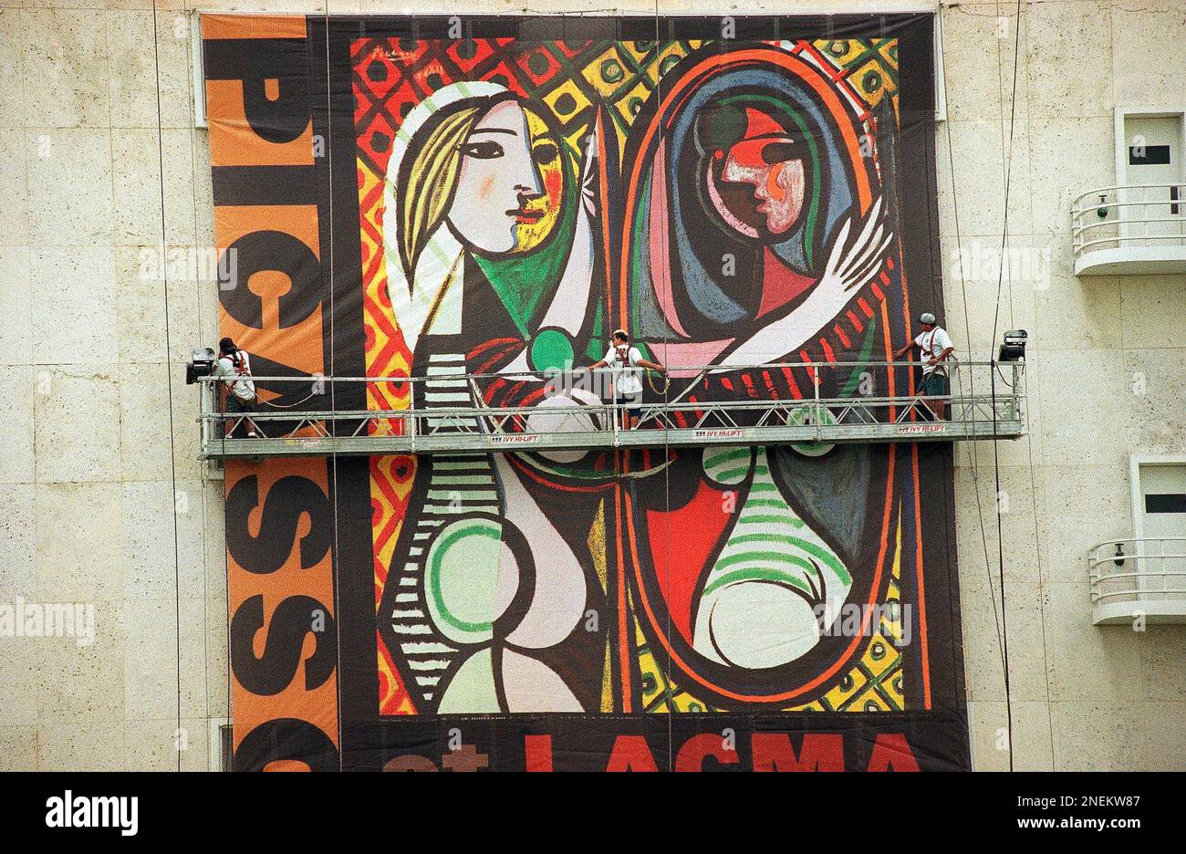 Los Angeles County Museum of Art workers hang a huge banner promoting ...
