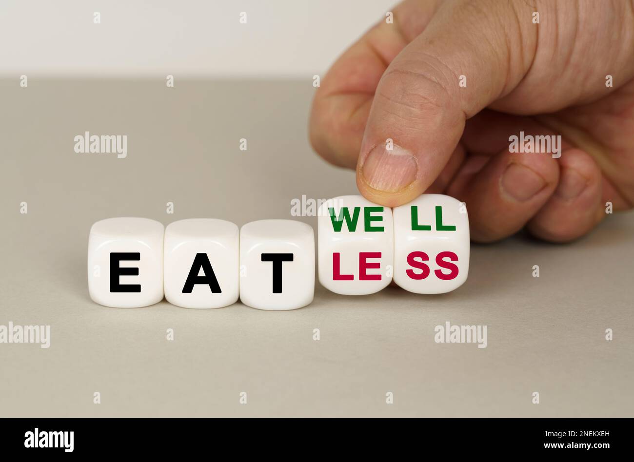 On a gray surface are white cubes with the inscription - eat well to ...
