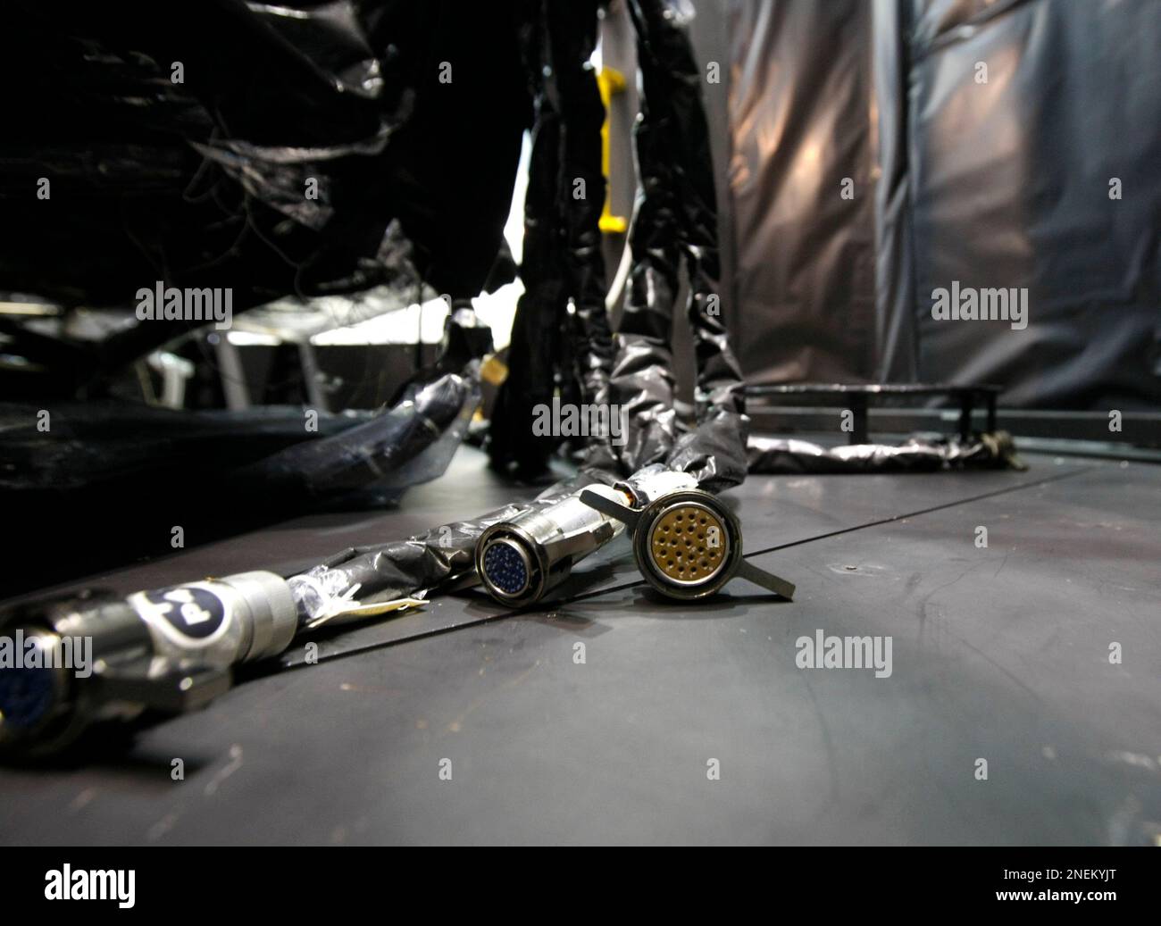 Cable connections lie on the floor of a mock-up of the Hubble telescope ...