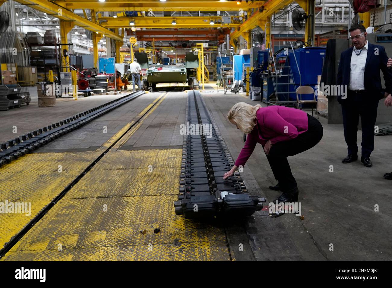Secretary of the Army Christine Wormuth touches the tank treads of the ...