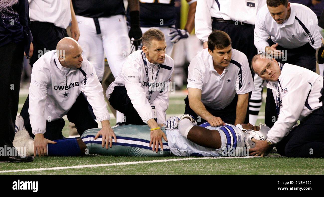 Dallas Cowboys linebacker DeMarcus Ware (94) is attended to by ...