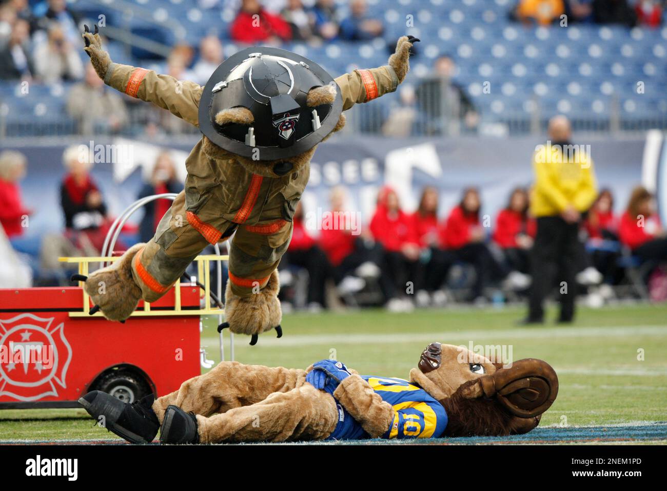 Tennessee Titans mascot T-Rac, top, jumps on a St. Louis Rams mascot ...