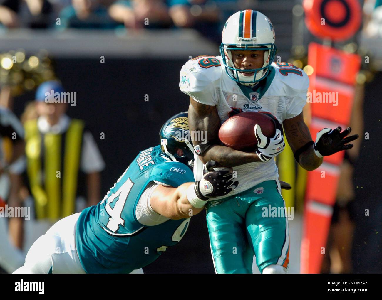 Miami Dolphins wide receiver Ted Ginn is tackled by Jacksonville ...