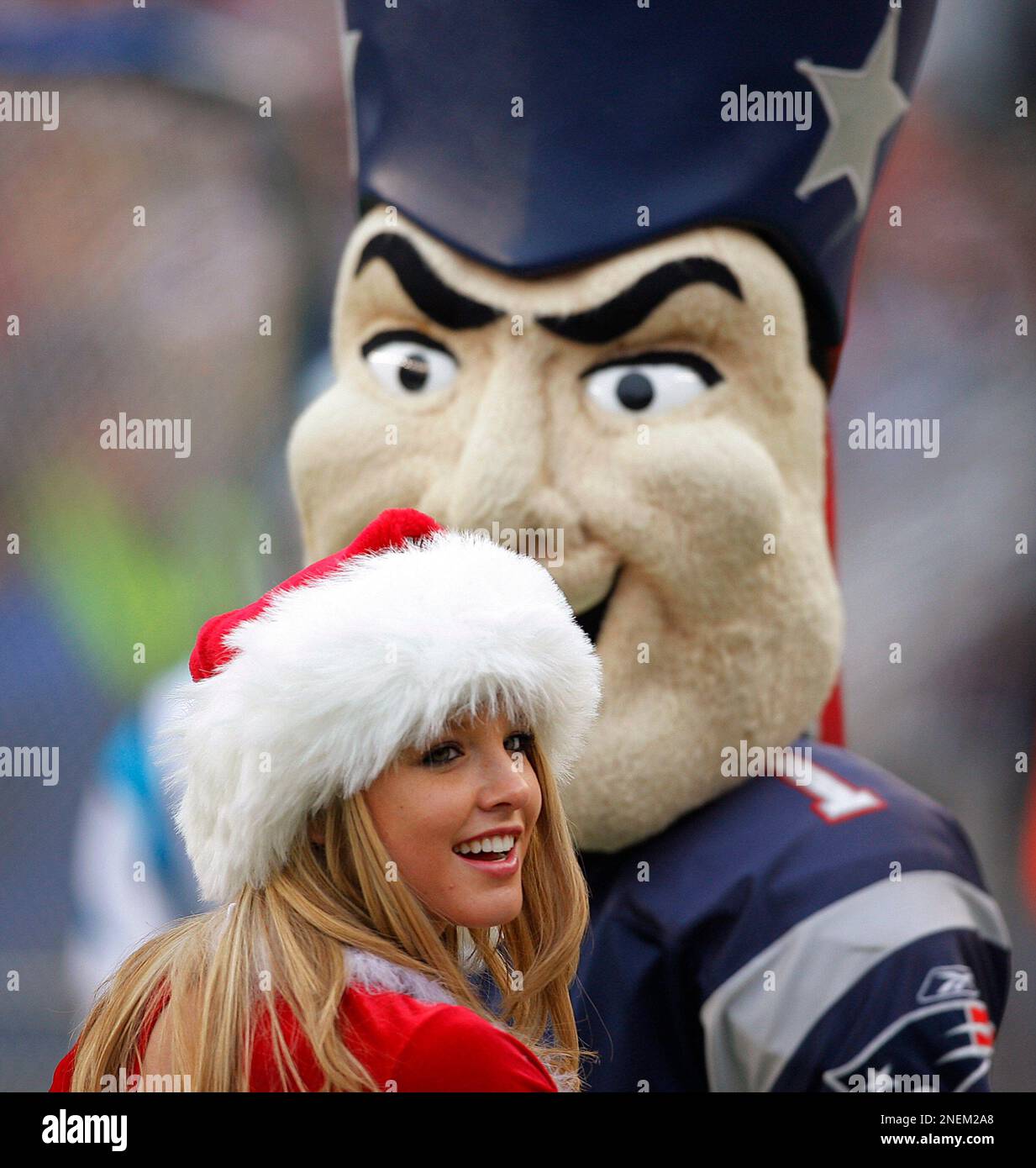 New England Patriots mascot "Pat Patriot" and a cheerleader on the ...