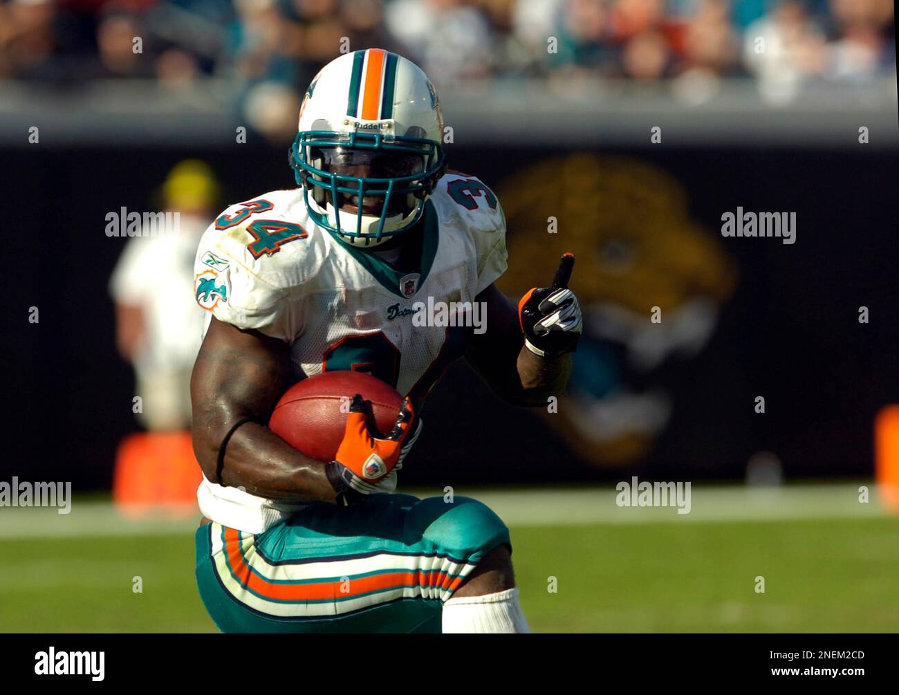 Miami Dolphins running back Ricky Williams looks for yardage against ...