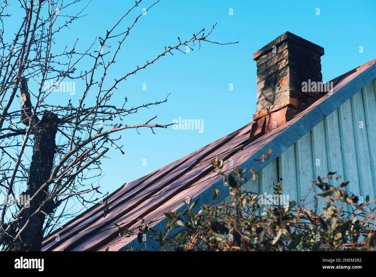 The rooftop of a house with a chimney Stock Photo - Alamy