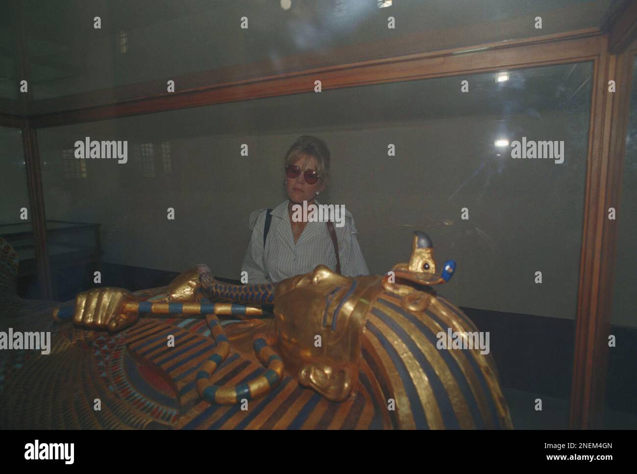 American actress Jane Fonda looks at the golden coffin of ancient ...
