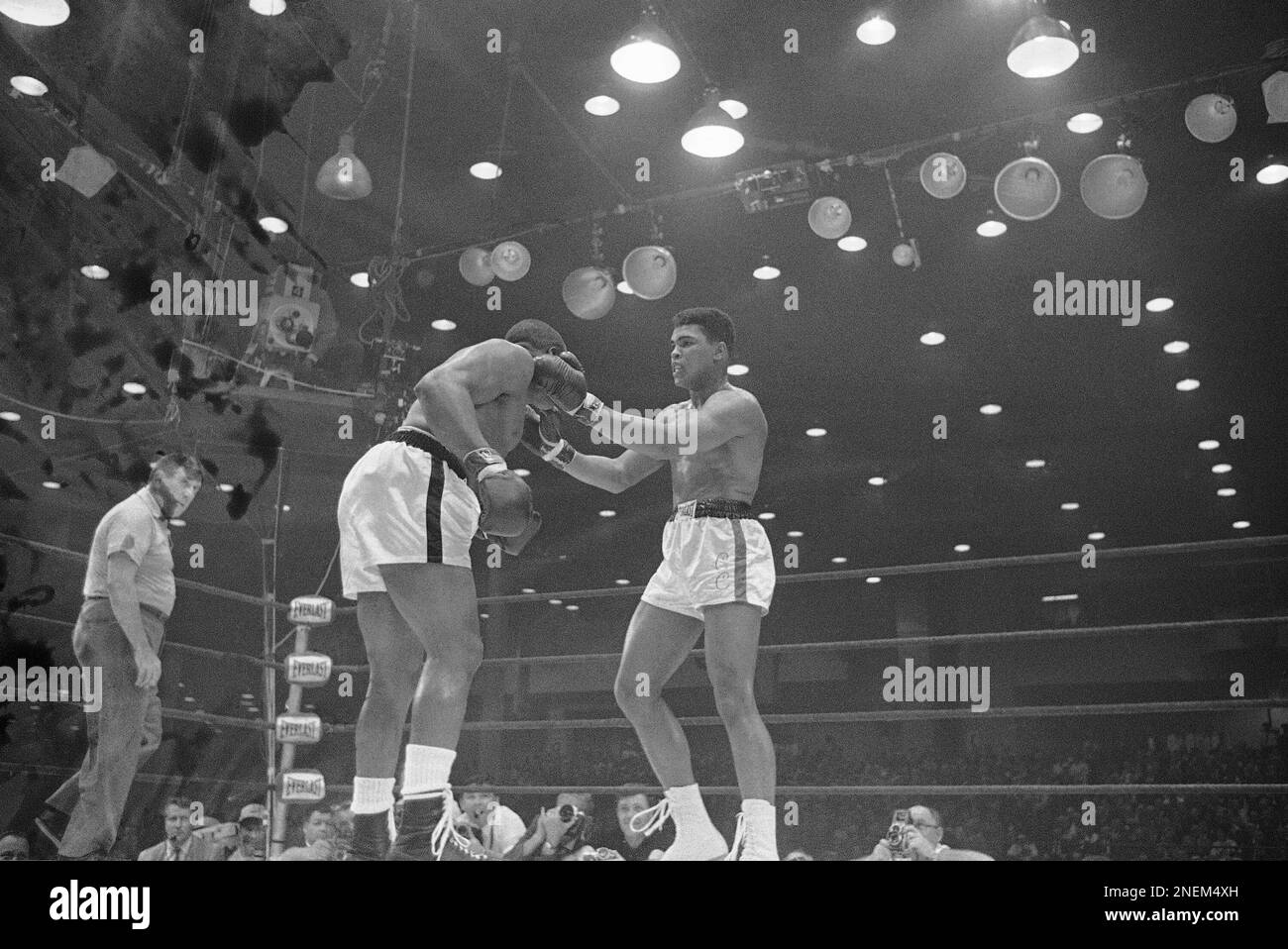 Muhammad Ali (Cassius Clay), right, appears to be boxing the ears of ...