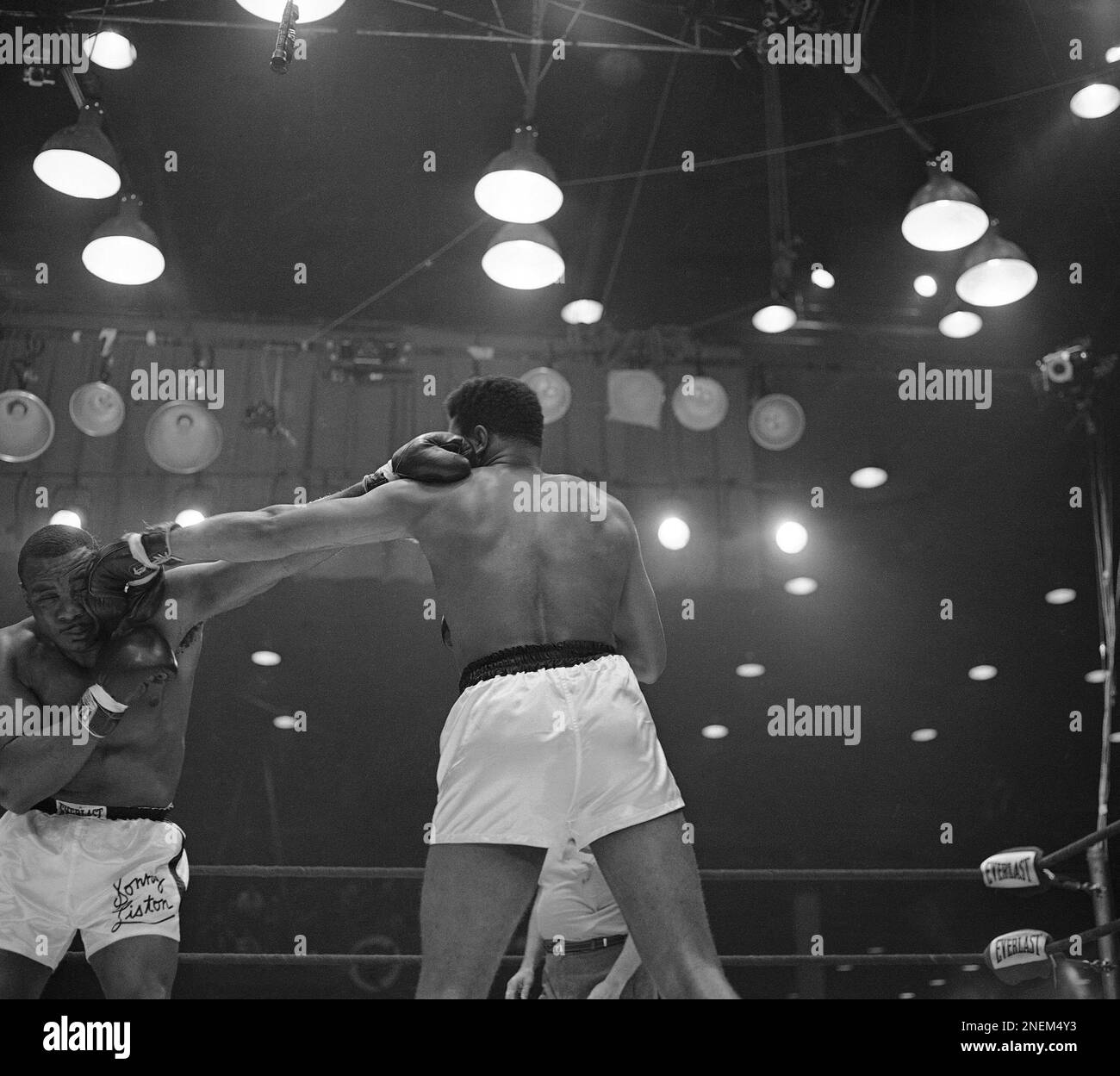 Muhammad Ali (Cassius Clay), right, pokes a long left into the left eye ...