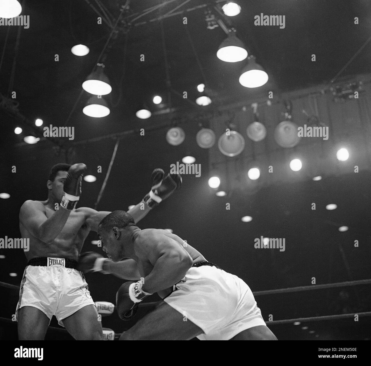 Sonny Liston bends low and lands punch as Muhammad Ali (Cassius Clay ...