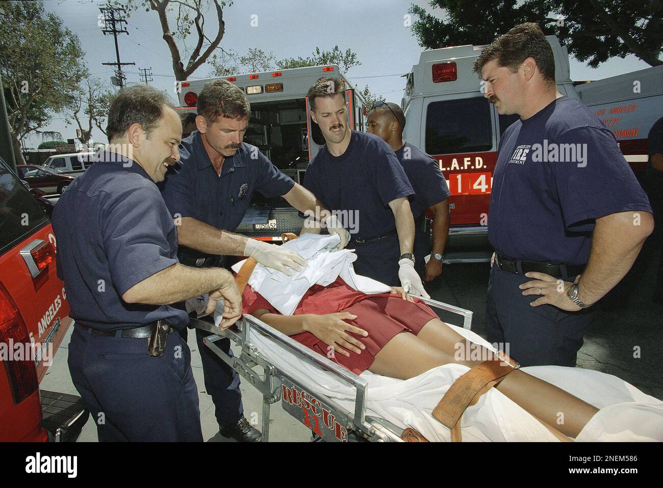 Los Angeles City firefighters and paramedics treat one of about 20 ...