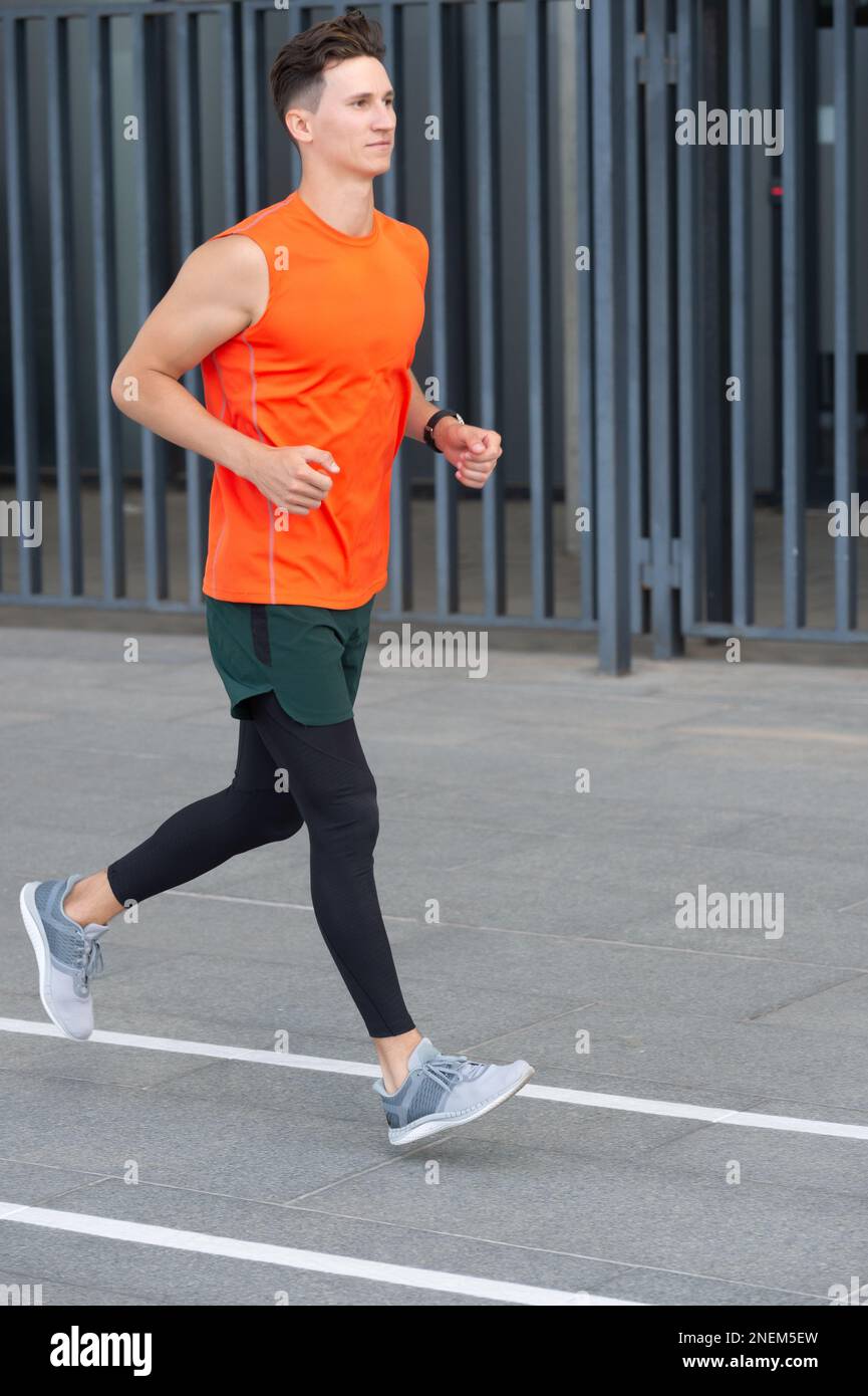 full length of runner man running outside. runner man running in the ...
