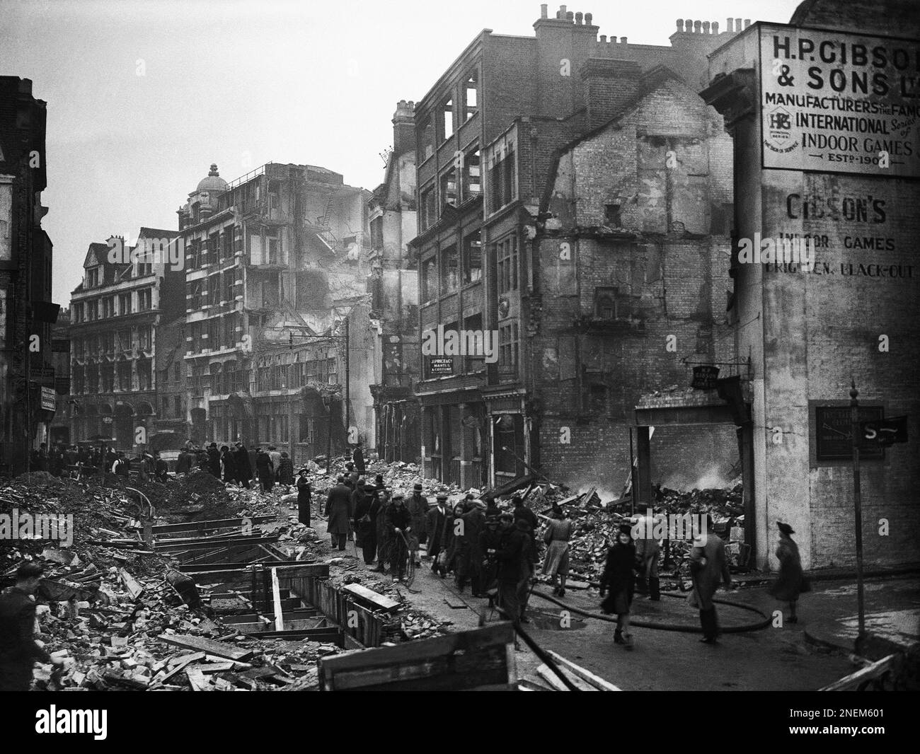 Londoners walking through a small path left between debris of damaged ...
