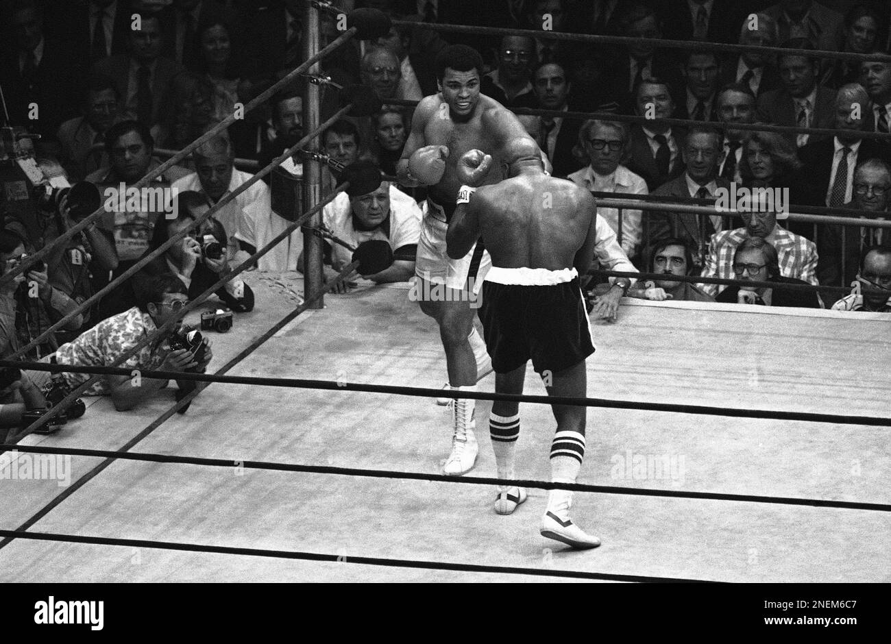 Heavyweight champion Muhammad Ali drops his arms to his side and ...