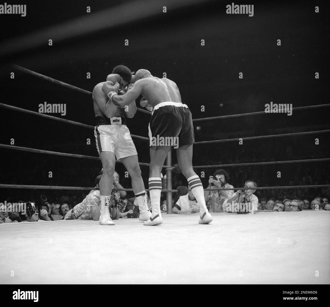 Muhammad Ali, left, holds gloves up to his head and grimaces as Earnie ...
