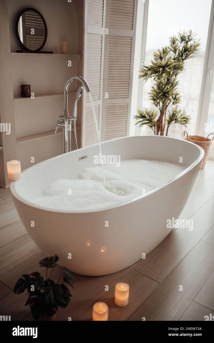 Soft native hues organic shapes look of bathroom with big window oval ...