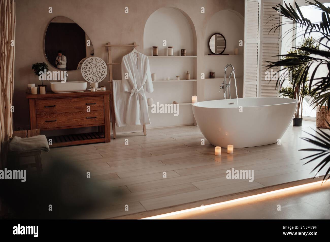 Soft native hues organic shapes look of bathroom with big window oval ...