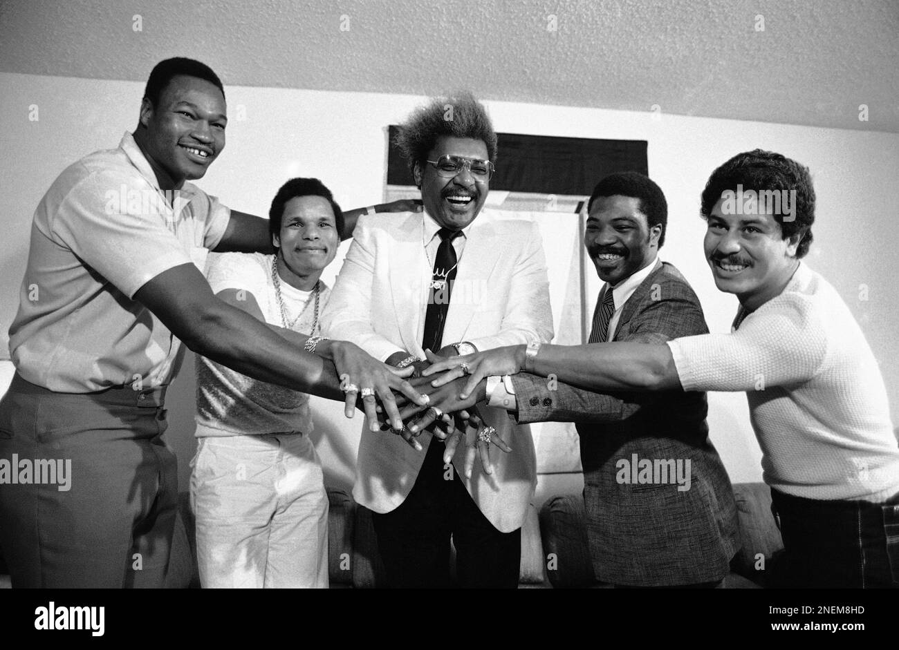 Boxing promoter Don King, center, and his circle of boxing champs have ...