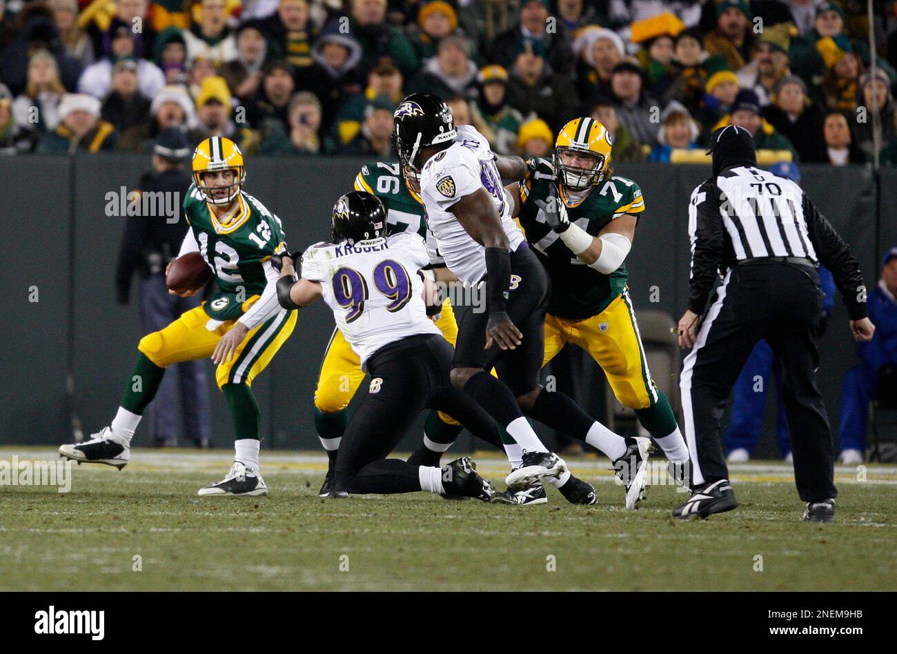 Green Bay Packers quarterback Aaron Rodgers tries to scramble away from ...