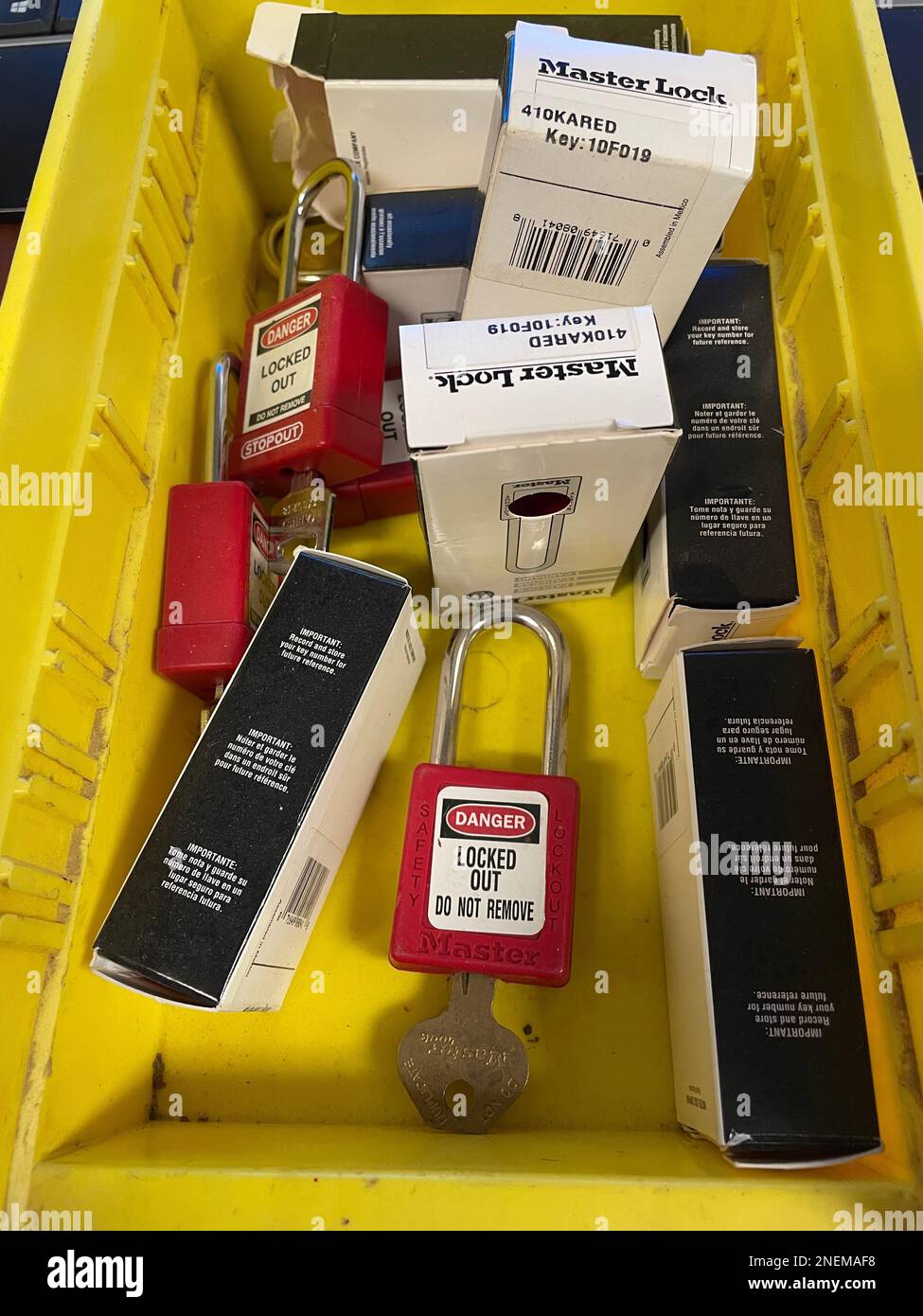 Lock out tag out locks locks in a yellow tote. High quality photo Stock ...